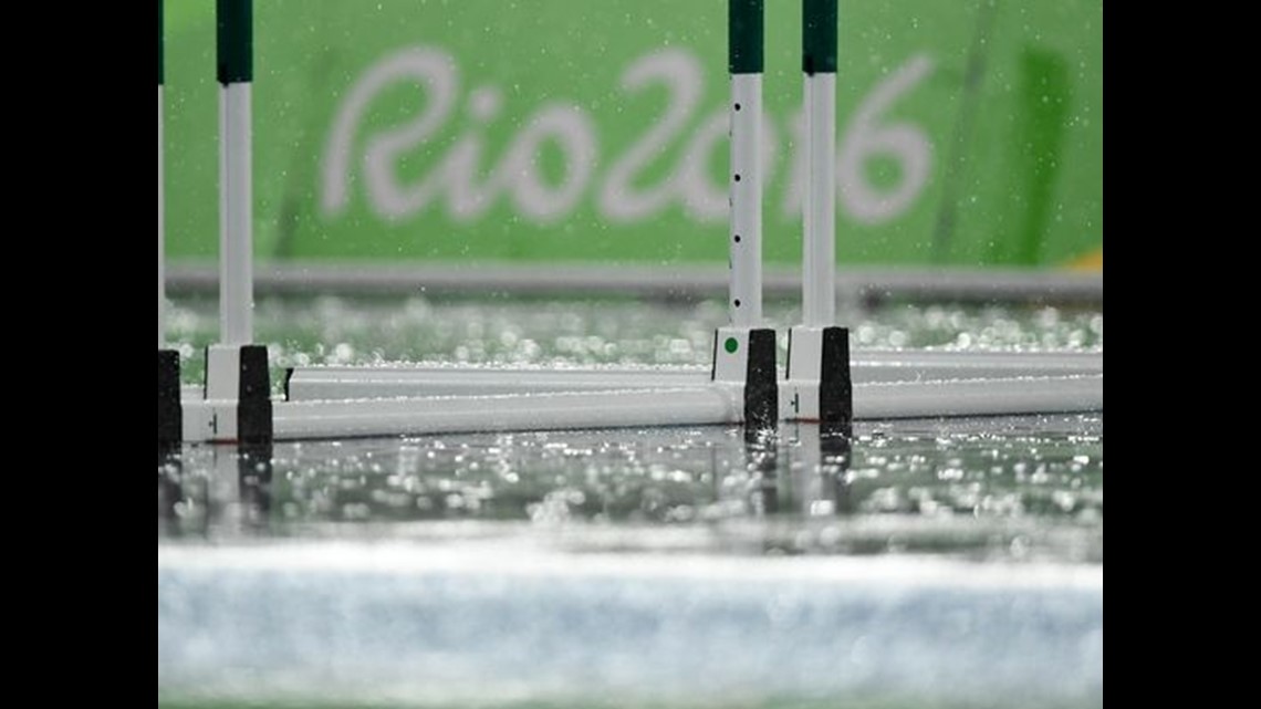 Pouring rain adds another hurdle to Olympic track and field | wusa9.com