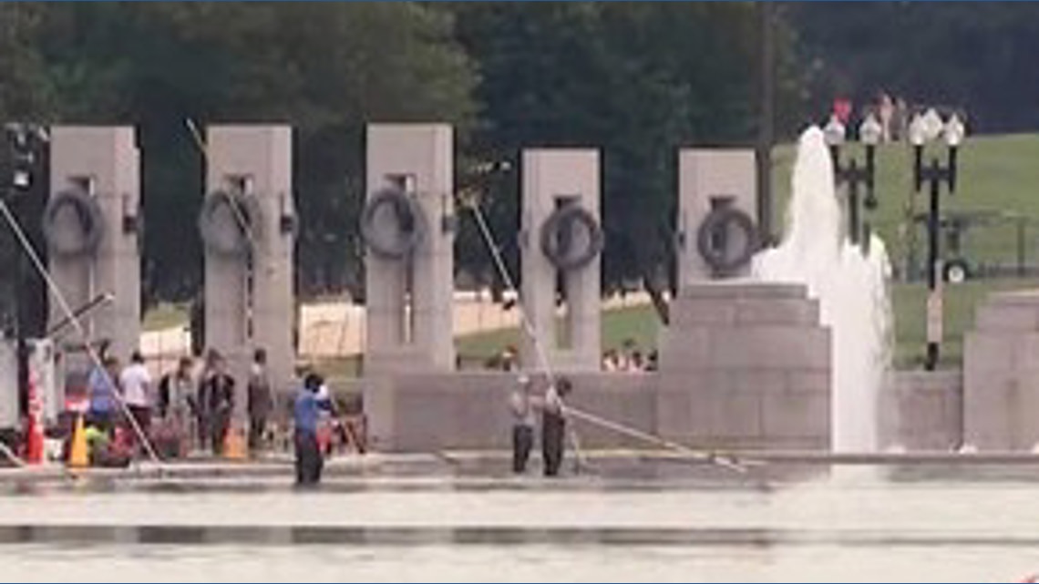 Workers spotted wading through Reflecting Pool while treating algae ...
