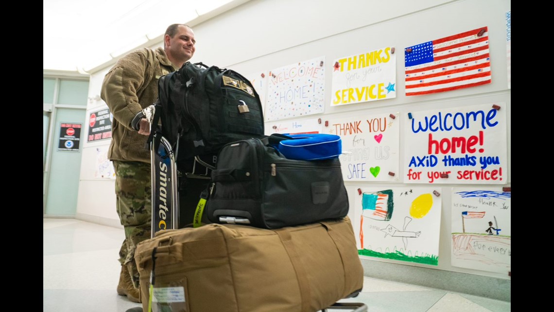 Welcome home: Community, family members greet military at airport ...