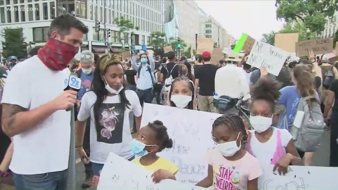 Mother protests in DC with four young daughters | wusa9.com
