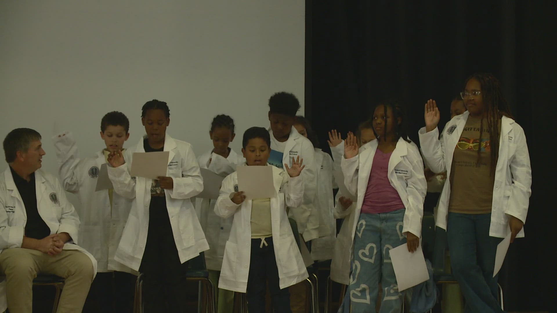 Tubman Elementary students get medical school-style graduation | wusa9.com